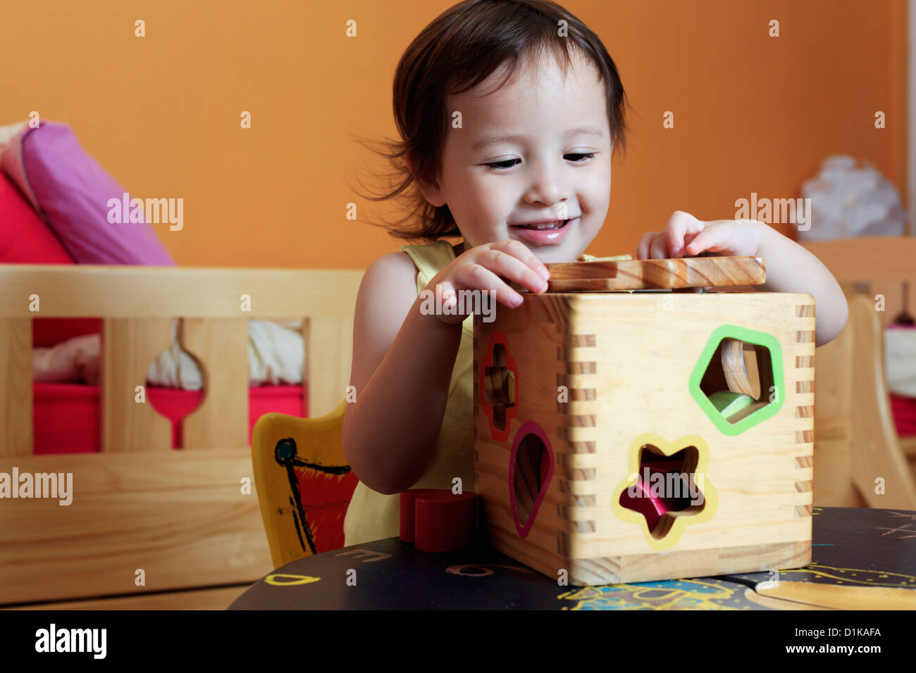 Young girl playing with blocks Stock Photo - Alamy