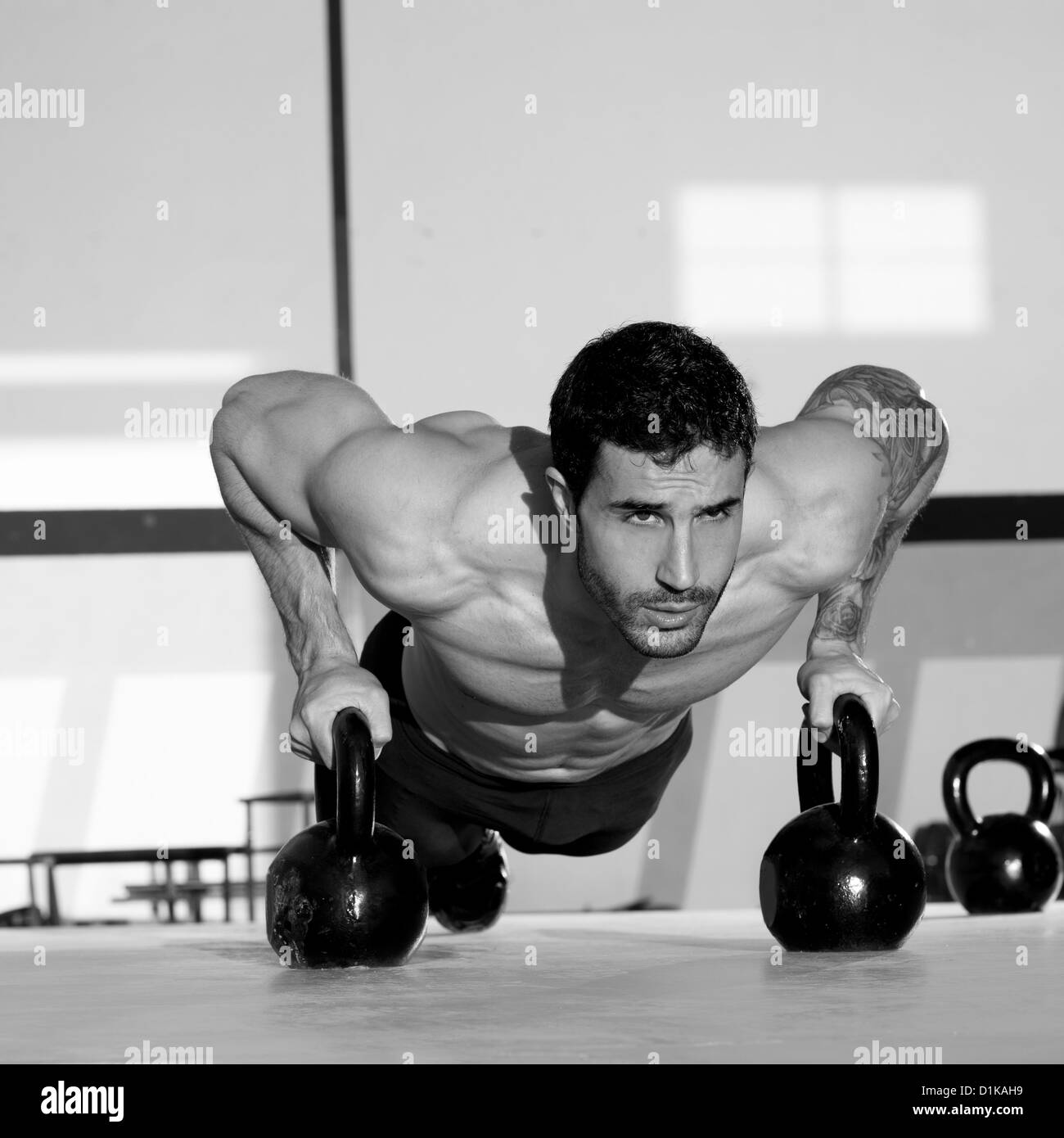 Gym man push-up strength pushup exercise with Kettlebell in a crossfit ...
