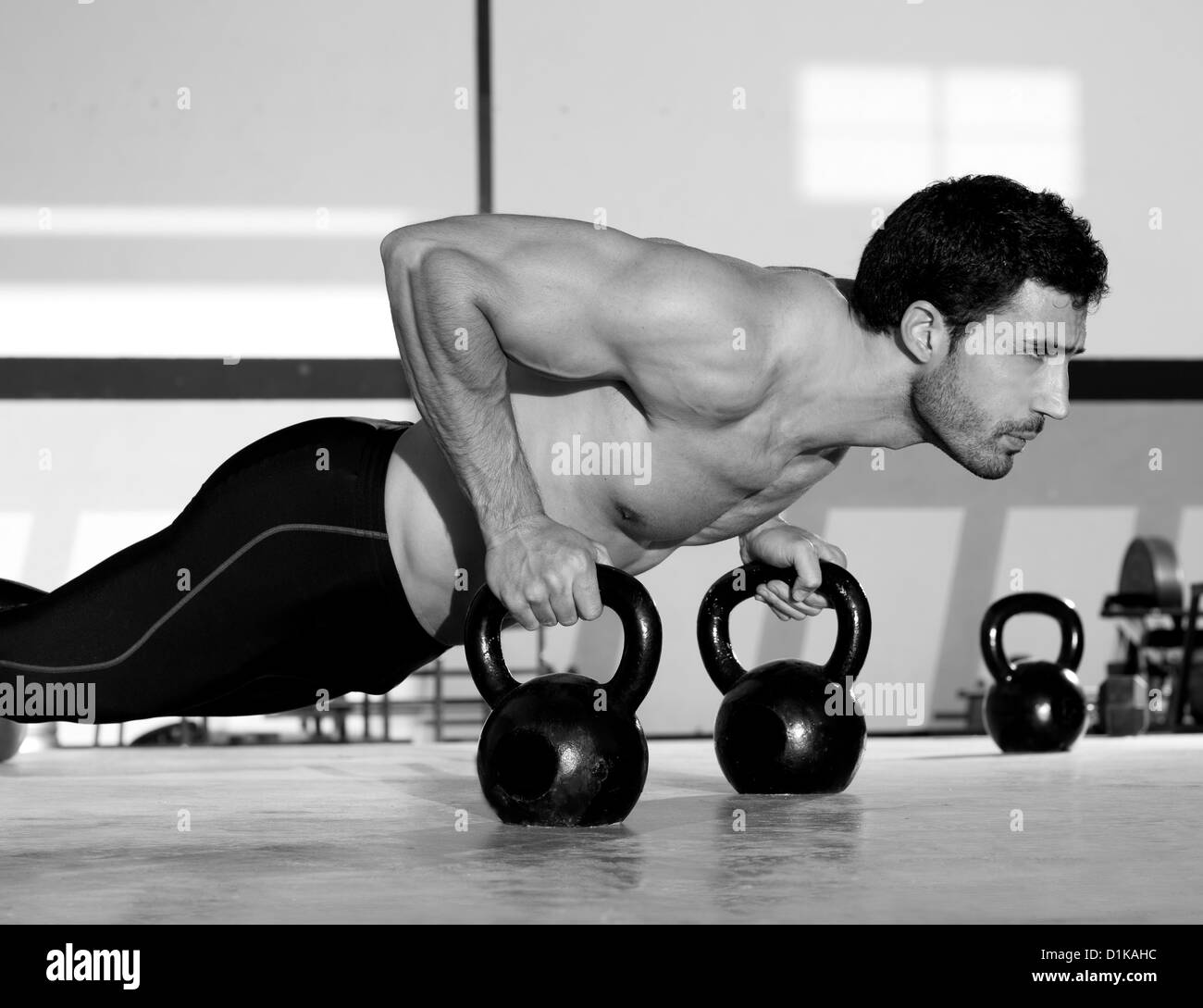 Gym man push-up strength pushup exercise with Kettlebell in a crossfit ...