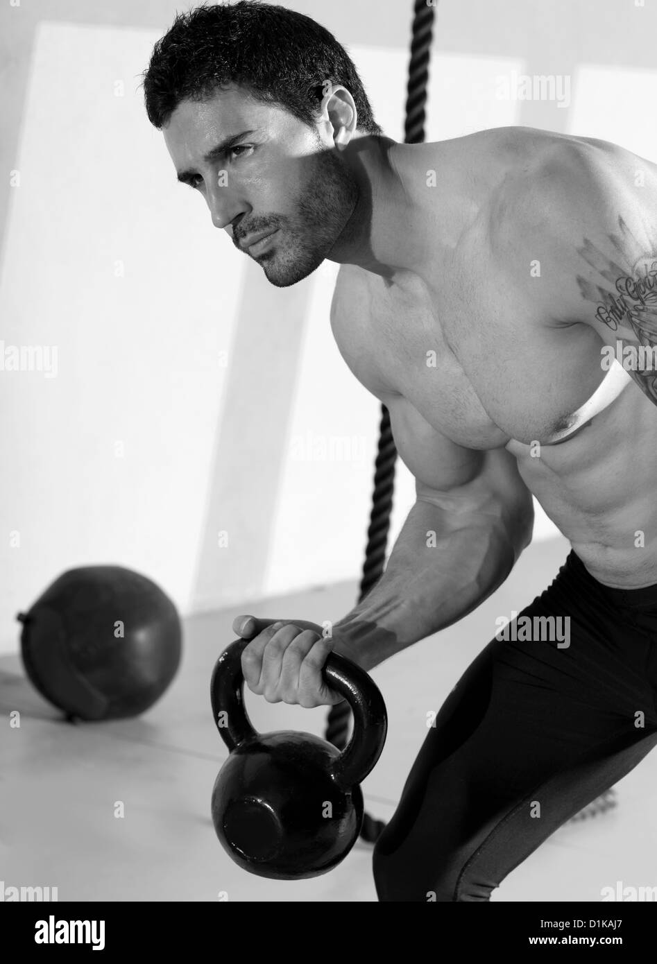 Crossfit man lifting kettlebell workout exercise at gym Stock Photo - Alamy