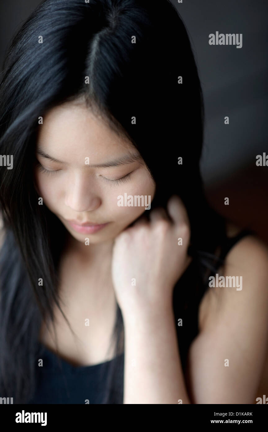 Head shot young woman looking down Stock Photo - Alamy