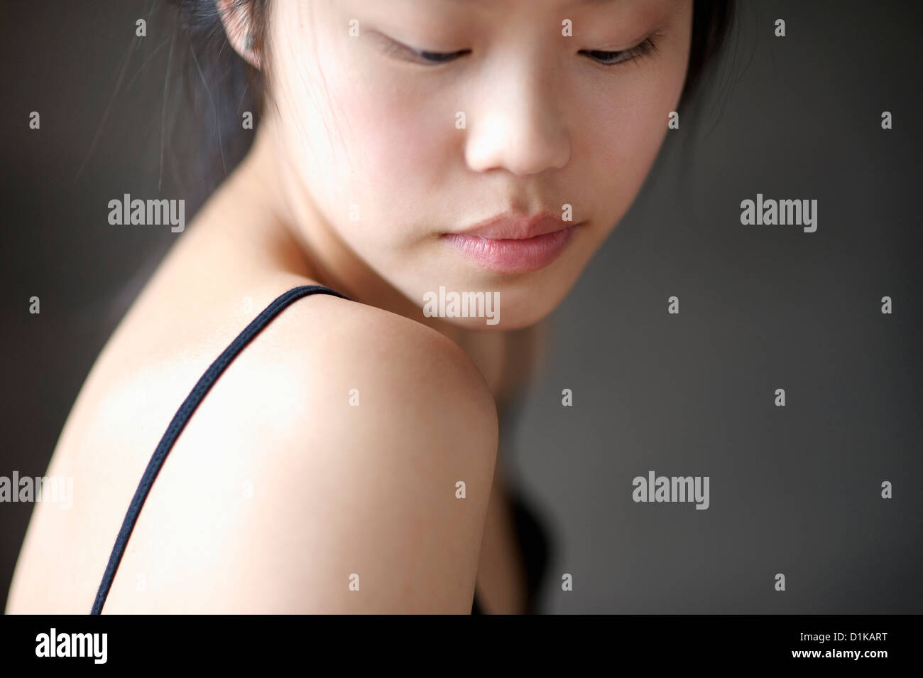 Head shot of woman looking over her shoulder Stock Photo - Alamy