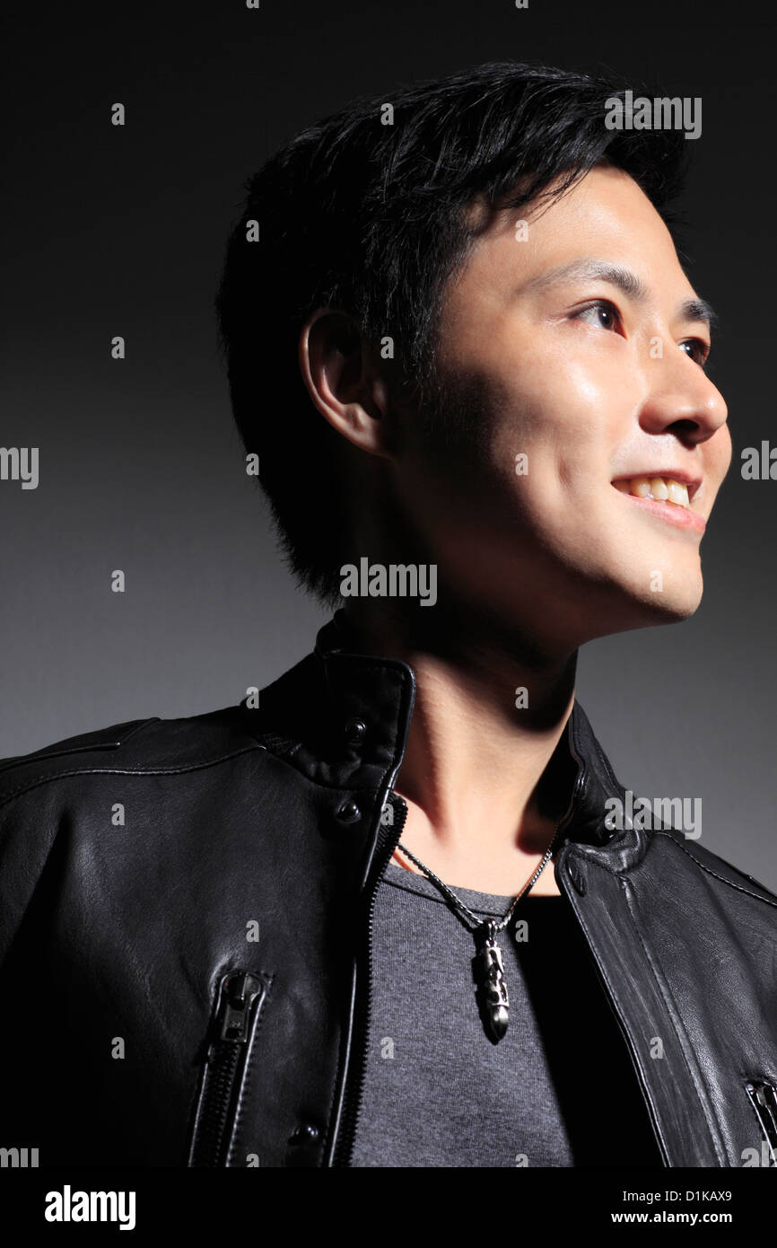 Head shot of profile of young man smiling in leather jacket Stock Photo ...