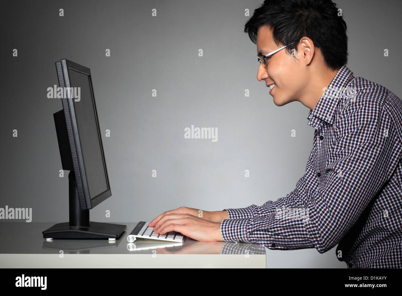 Profile of young man working on a computer Stock Photo - Alamy