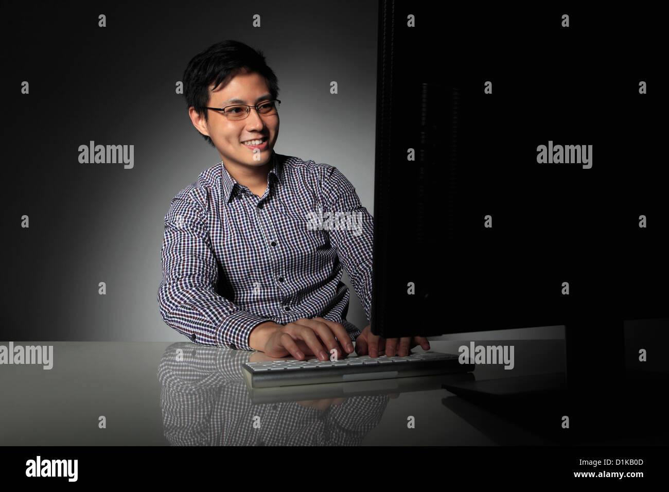 Young man working computer hi-res stock photography and images - Alamy
