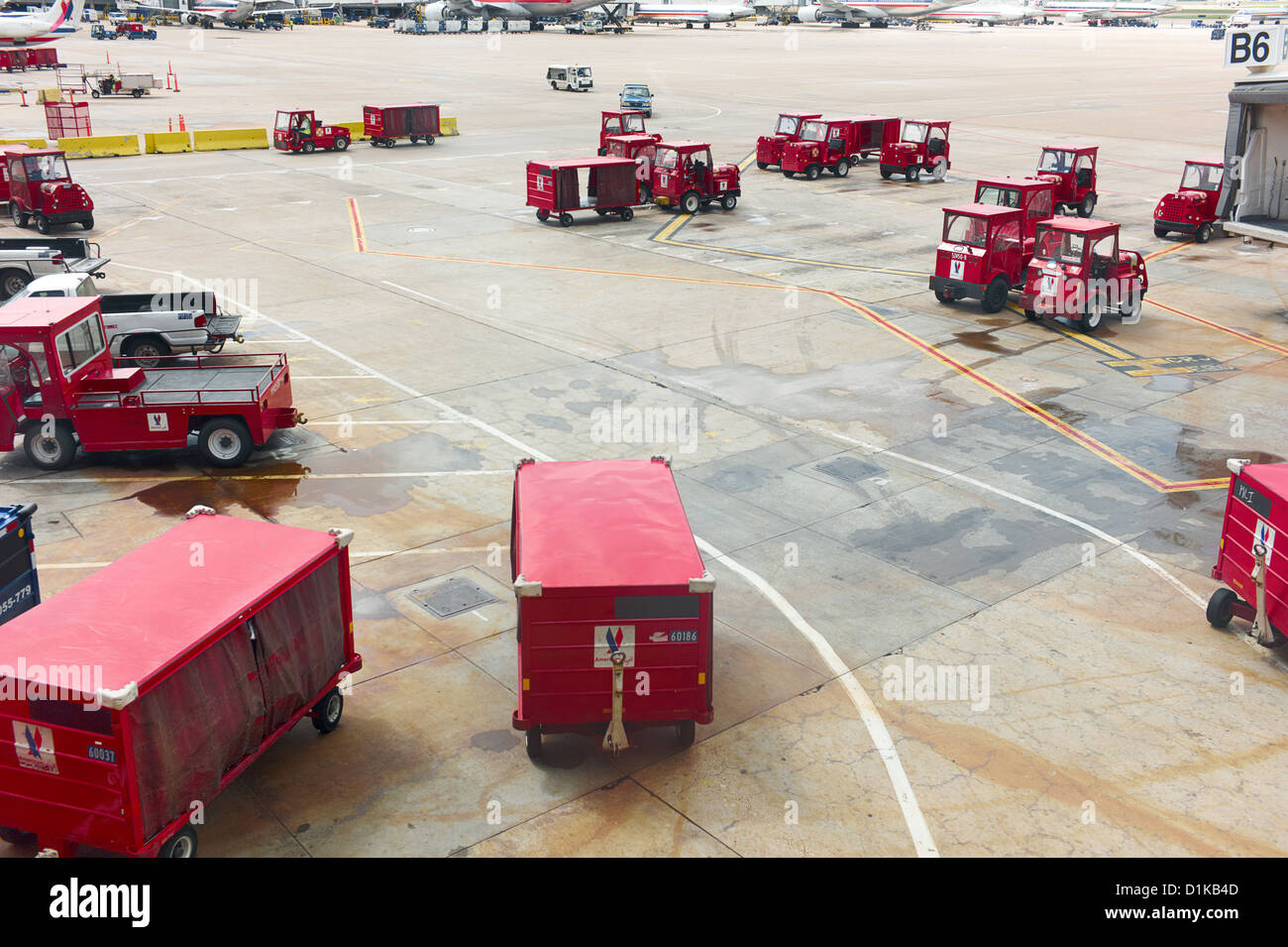 Red luggage containers on the tarmac of an airport Stock Photo - Alamy