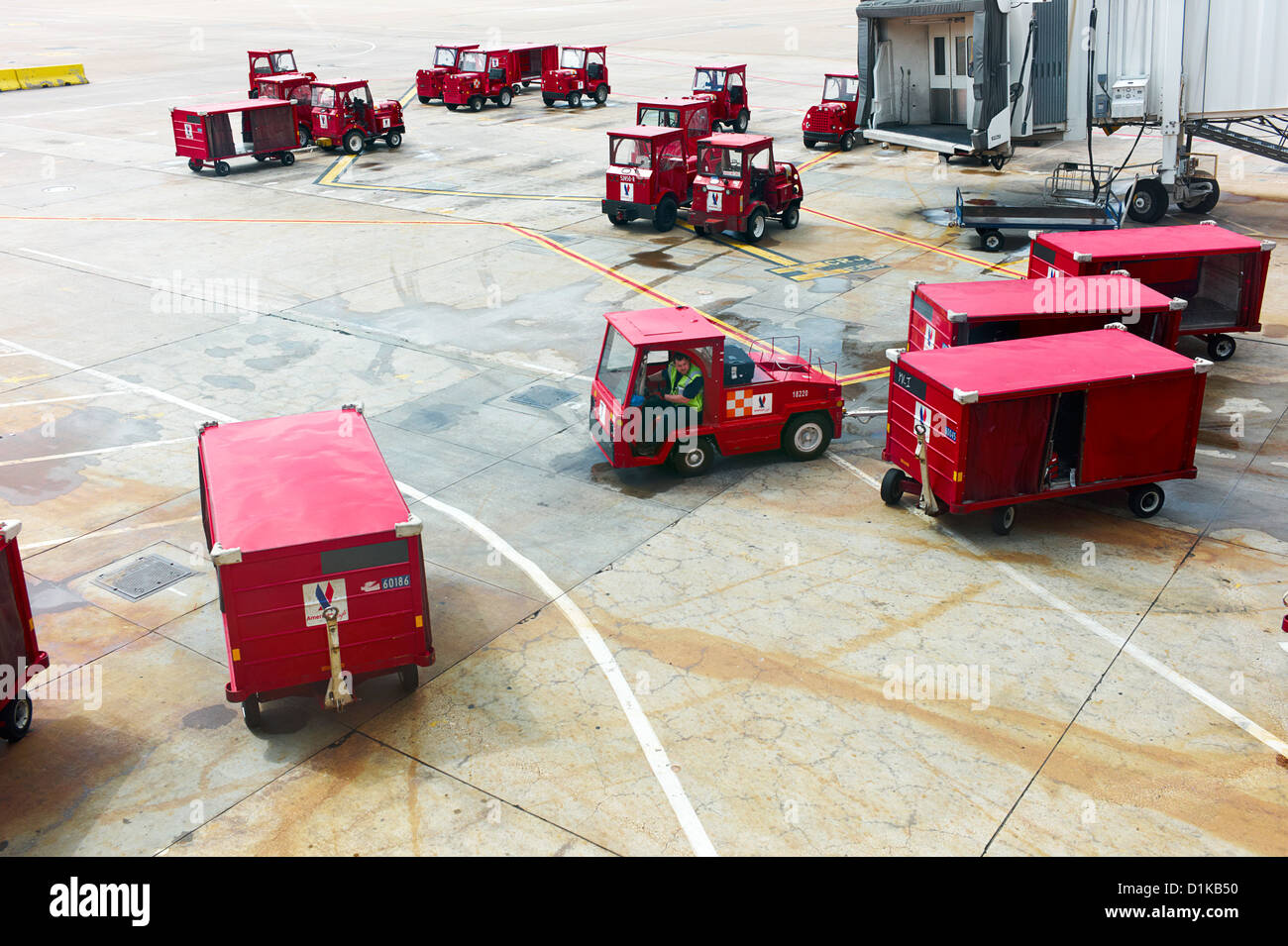Red luggage containers on the tarmac of an airport Stock Photo - Alamy