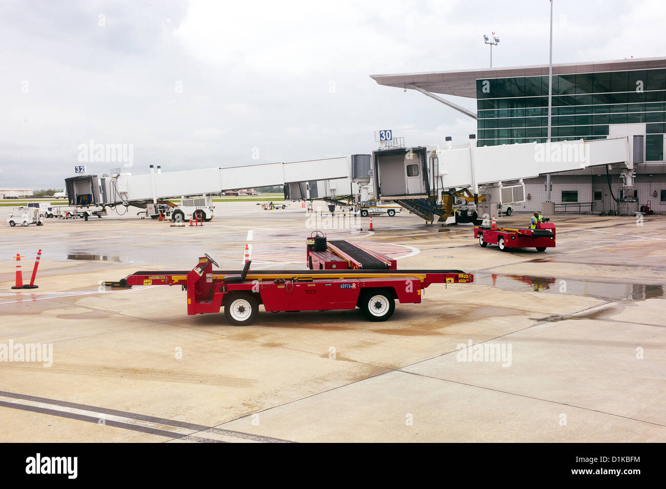 A red baggage loading car on an airport tarmac Stock Photo - Alamy