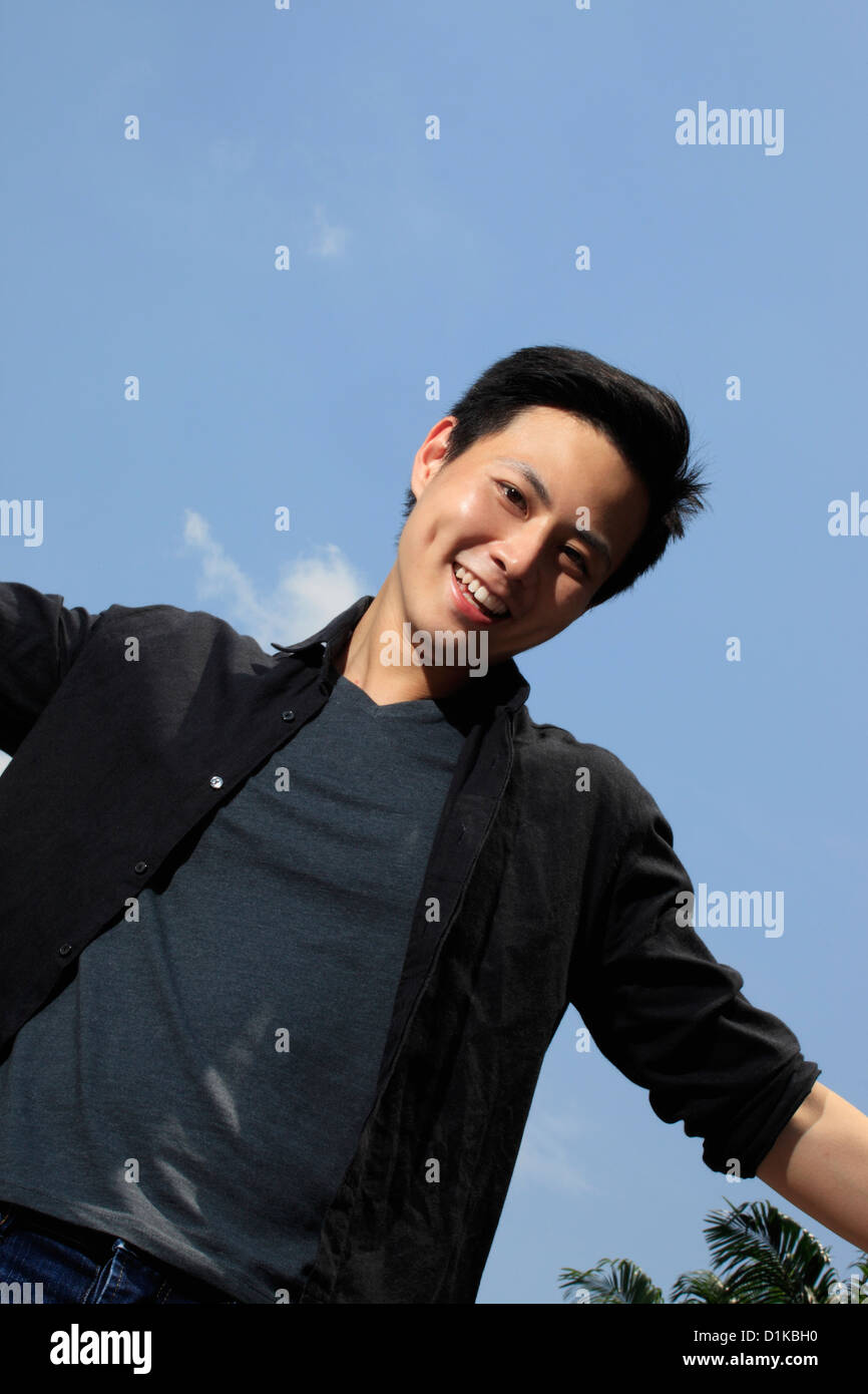 Portrait of young man smiling outside Stock Photo - Alamy