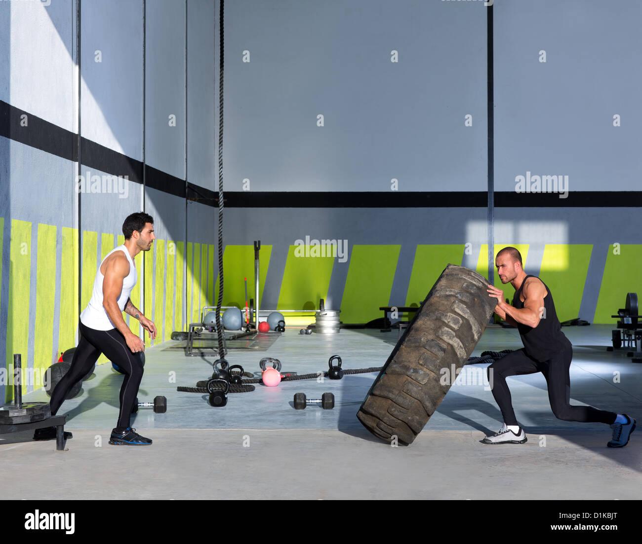 Crossfit flip tires men flipping each other the wheel workout Stock ...