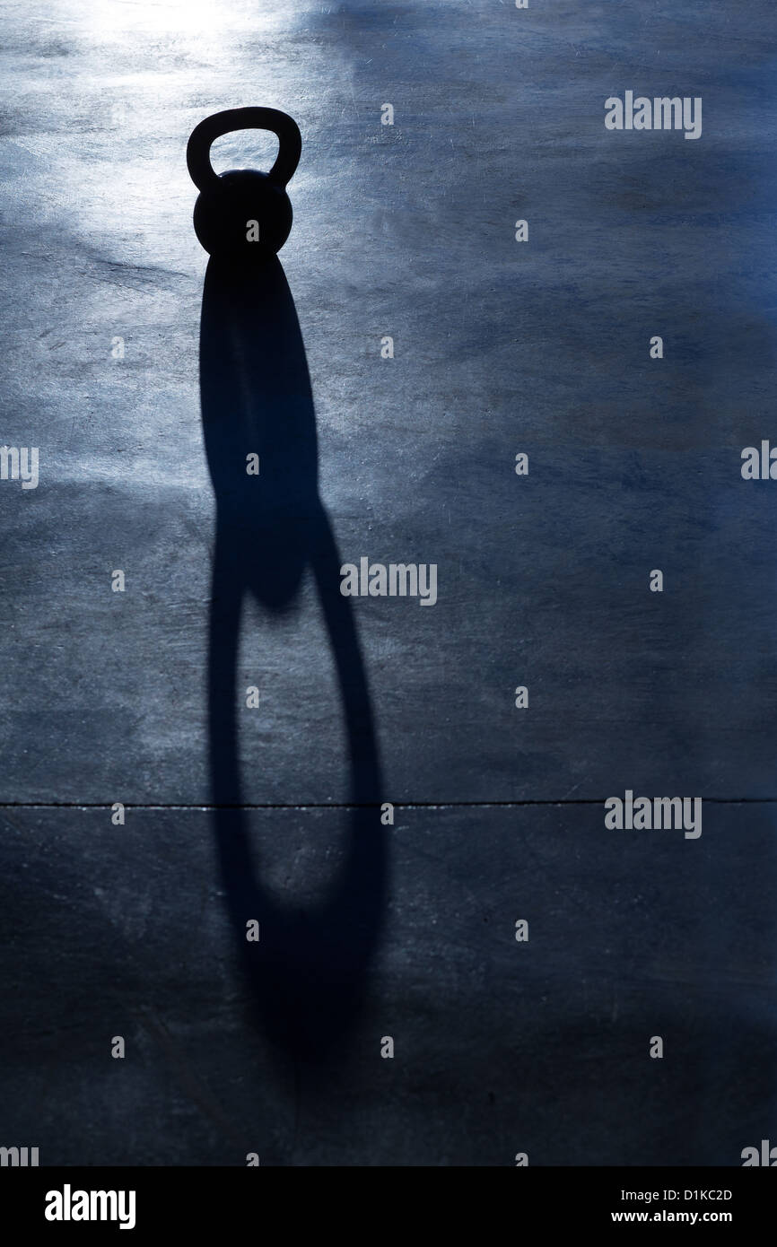Crossfit Kettlebell weight backlight and shadow on the gym floor Stock ...