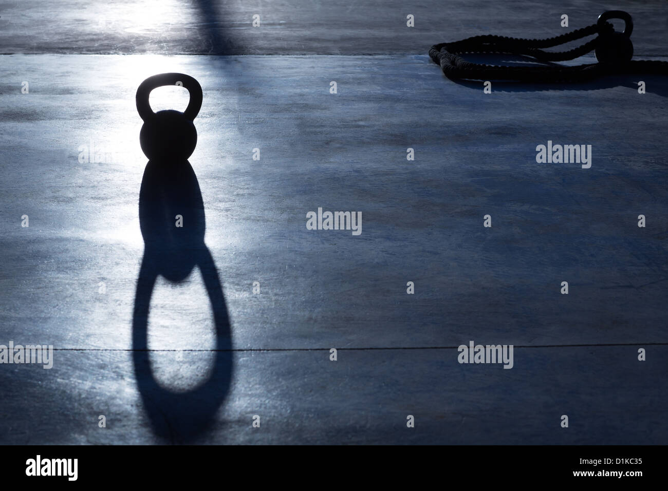 Crossfit Kettlebell weight backlight and shadow on the gym floor Stock ...