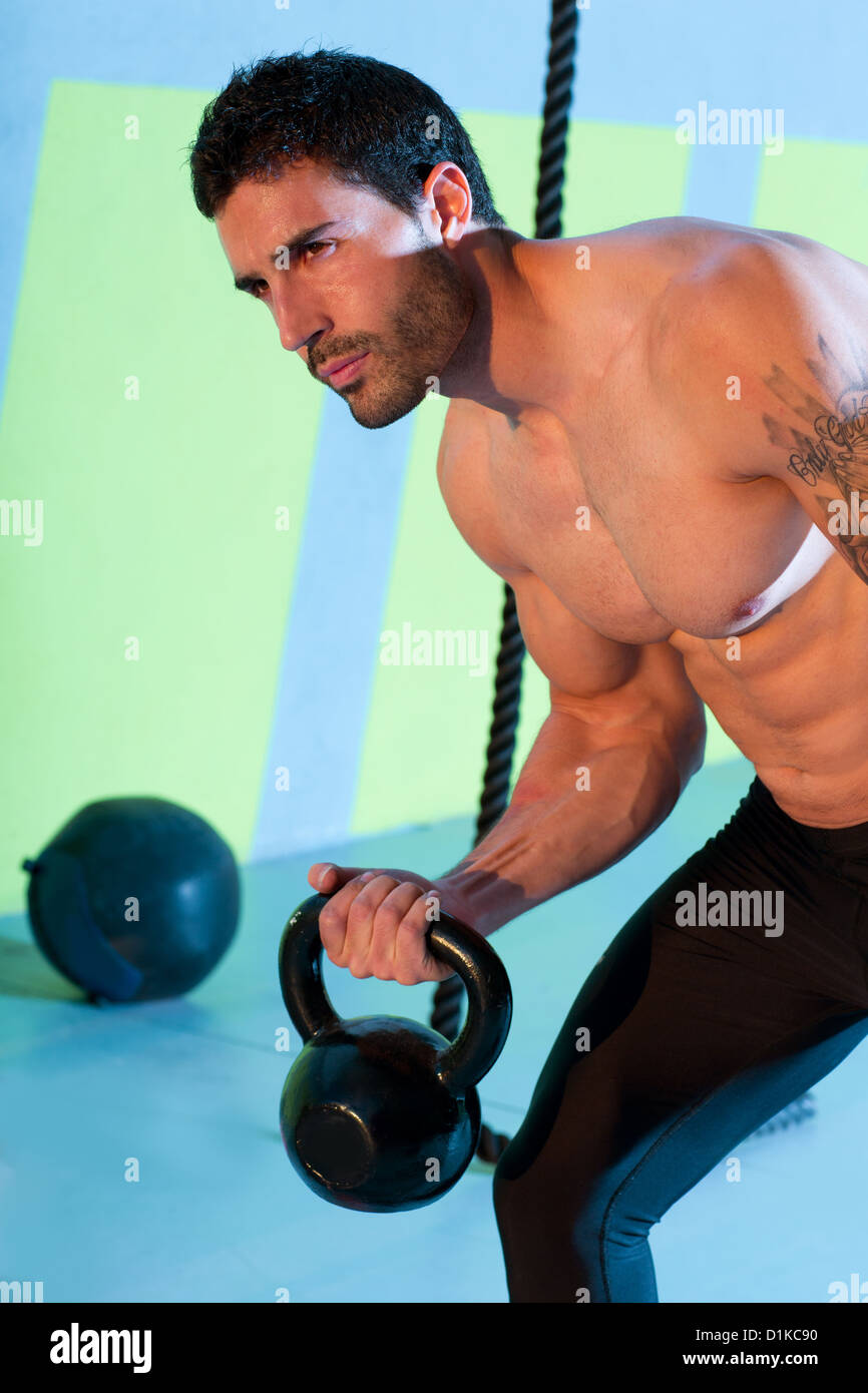 Crossfit man lifting kettlebell workout exercise at gym Stock Photo - Alamy