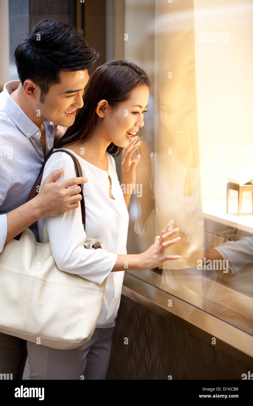 Sweet young couple doing window shopping in Hong Kong Stock Photo - Alamy