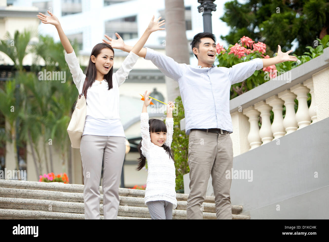 Happy young family arms raised on steps in Hong Kong Stock Photo - Alamy