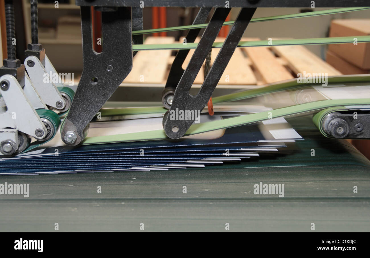 detail of a folding machine with print products Stock Photo - Alamy