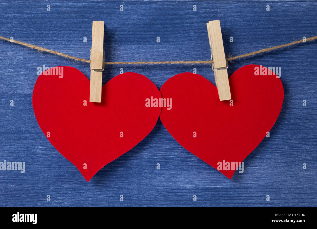 Two paper hearts hanging on a rope, valentines day theme Stock Photo ...