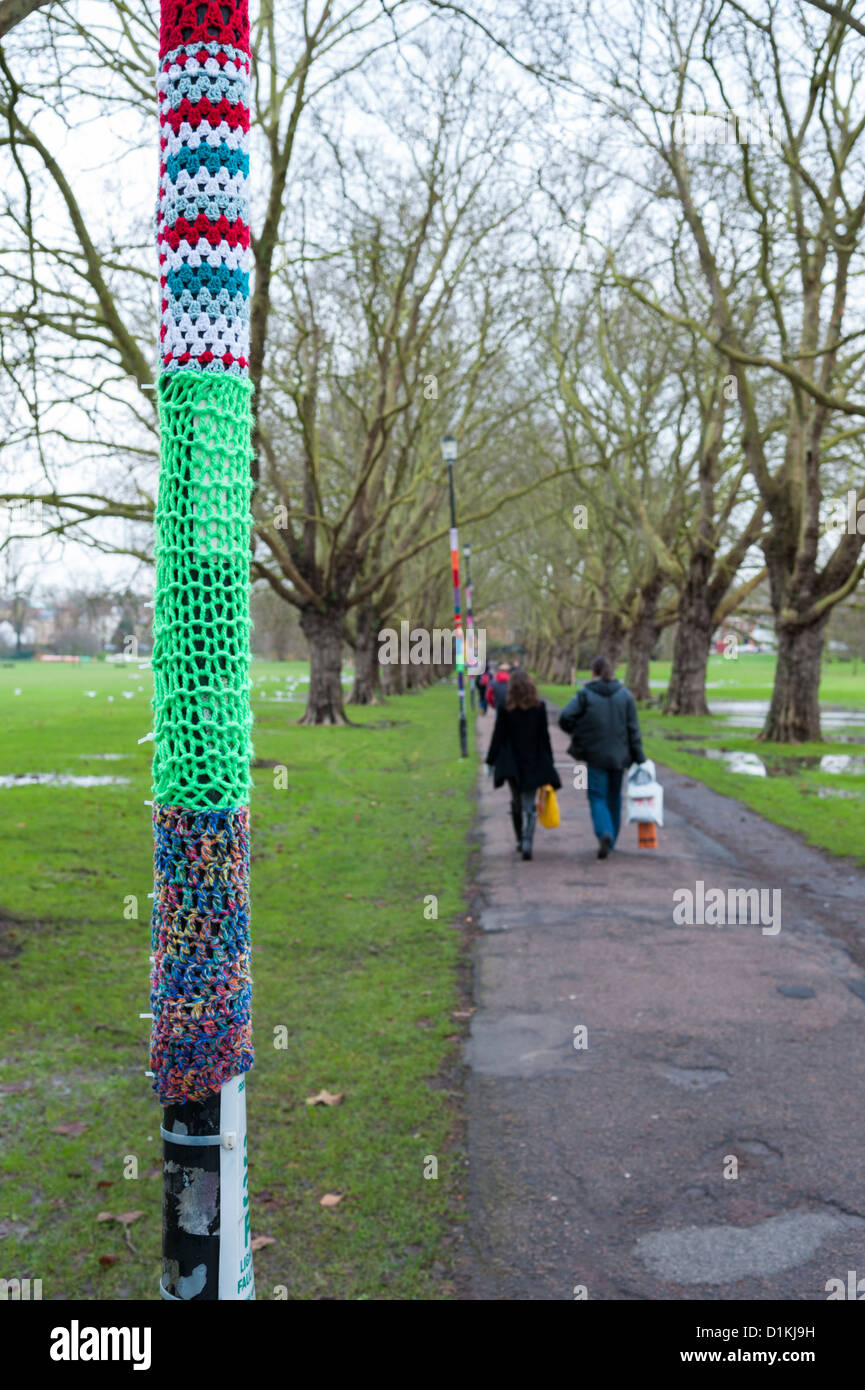 Lamposts are covered in knitting on Jesus Green Cambridge UK. This is ...