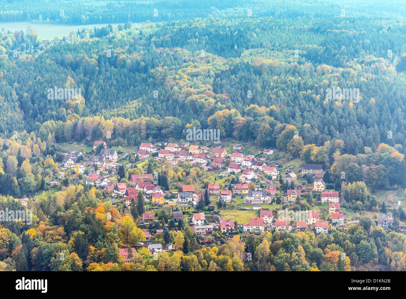 Village bordered with colored trees in saxony switzerland in autumn ...