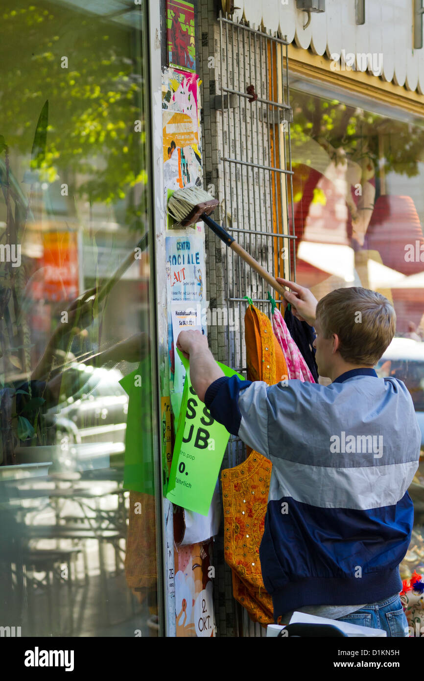 Man sticking Posters to a Wall in the Schanzenviertel in Hamburg ...