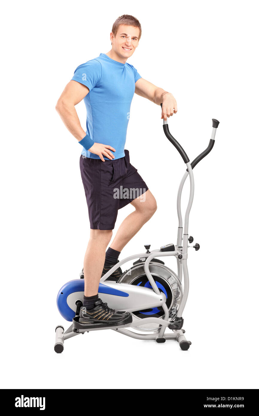 Full length portrait of an athlete standing on a cross trainer machine ...