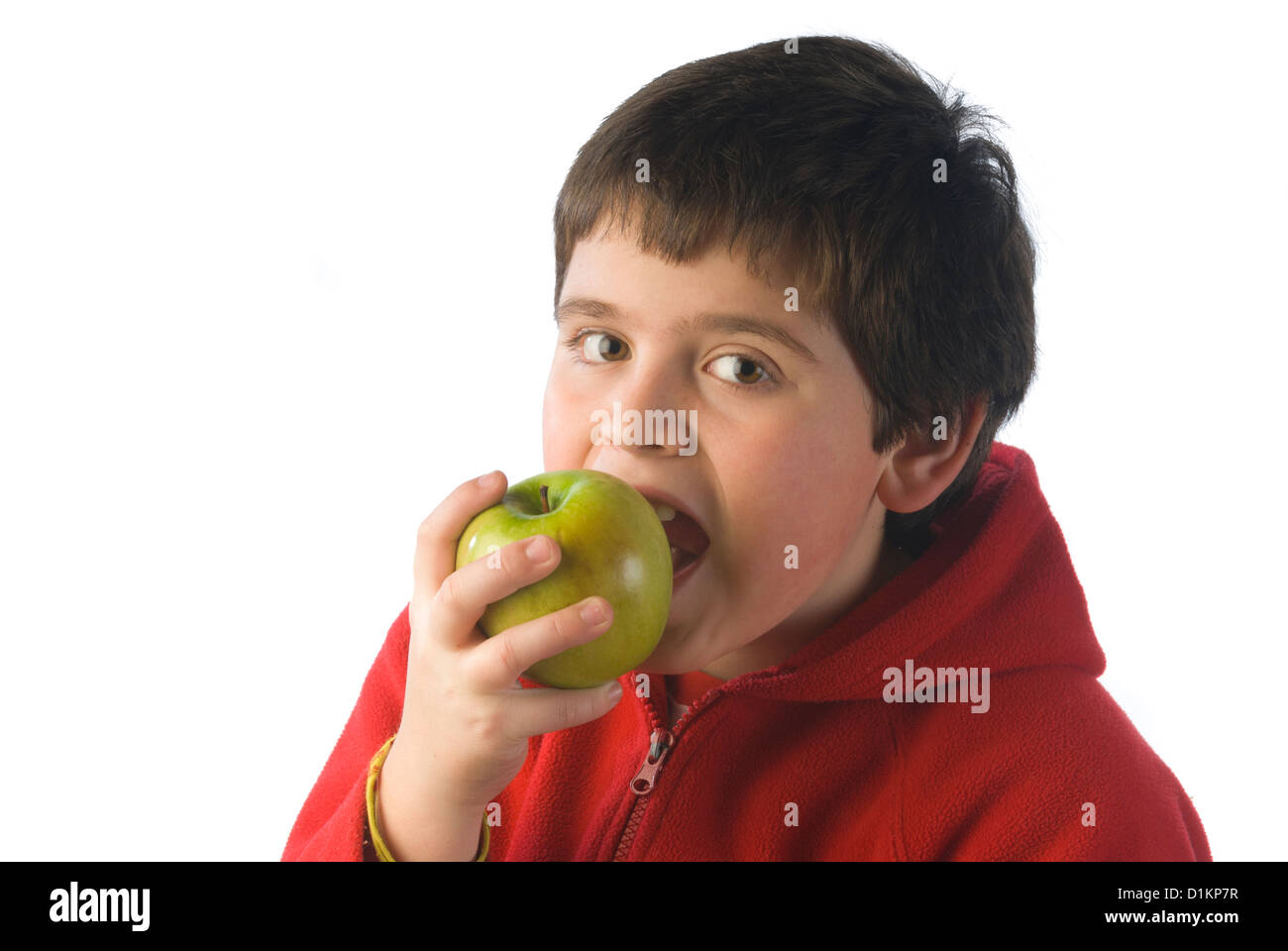 boy eating a green apple on the playground Stock Photo - Alamy