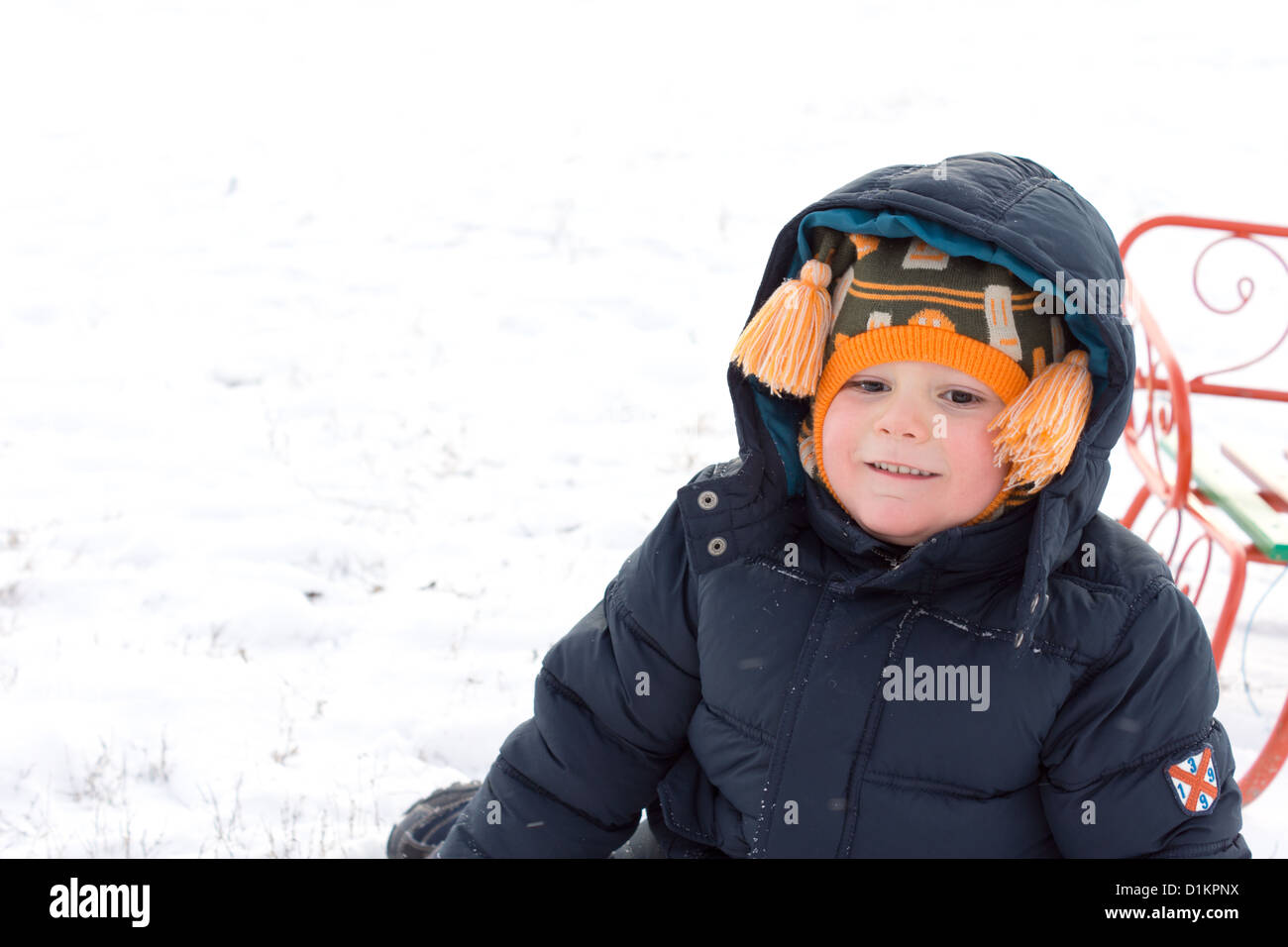 Cute little boy wrapped up warmly against the cold winter weather ...