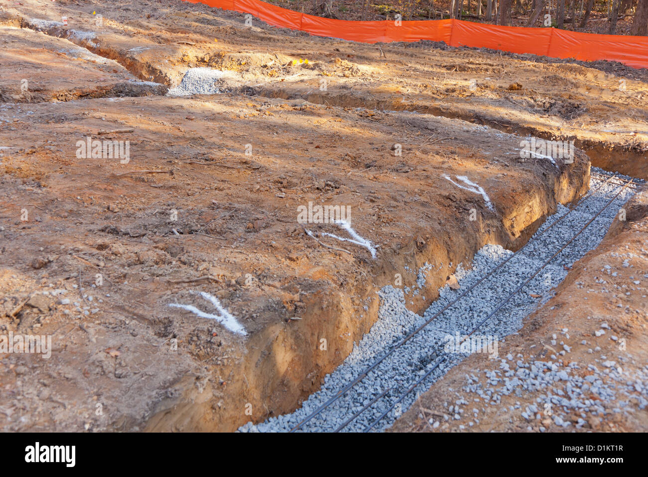 Trench filled with gravel and rebar on top in preparation for house ...