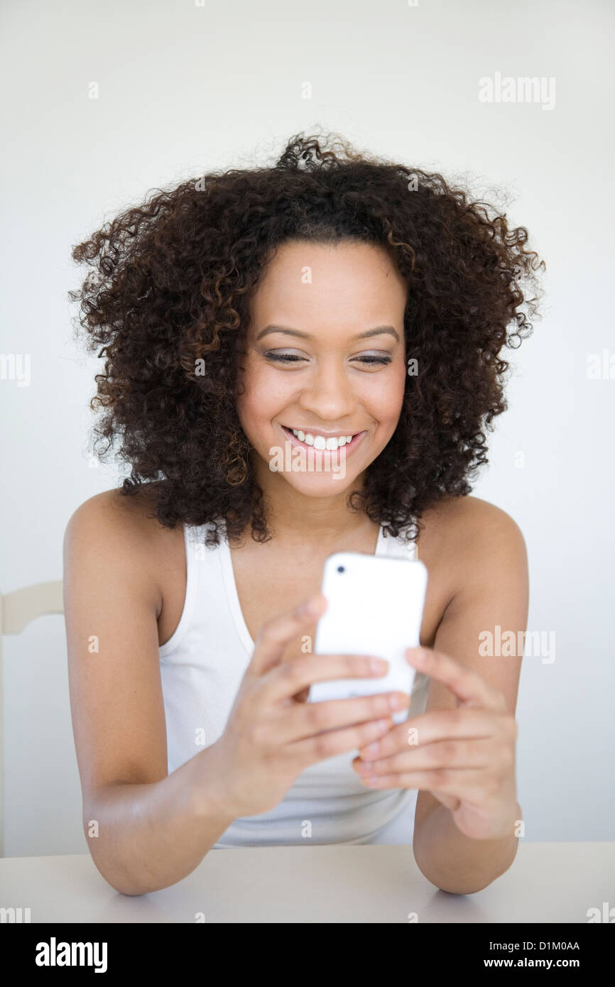 Hispanic woman text messaging on cell phone Stock Photo - Alamy
