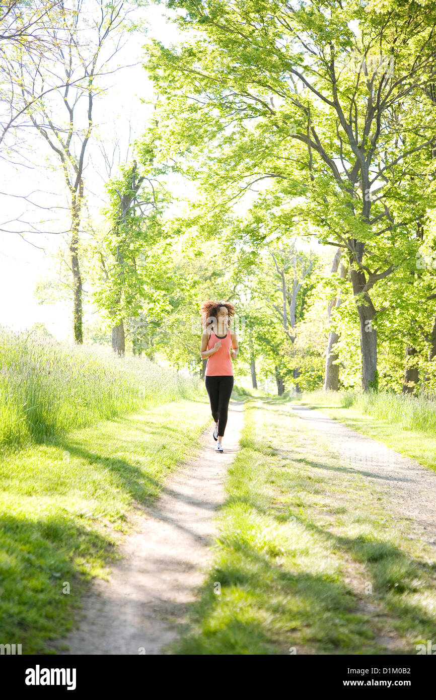 Hispanic woman running in park Stock Photo - Alamy