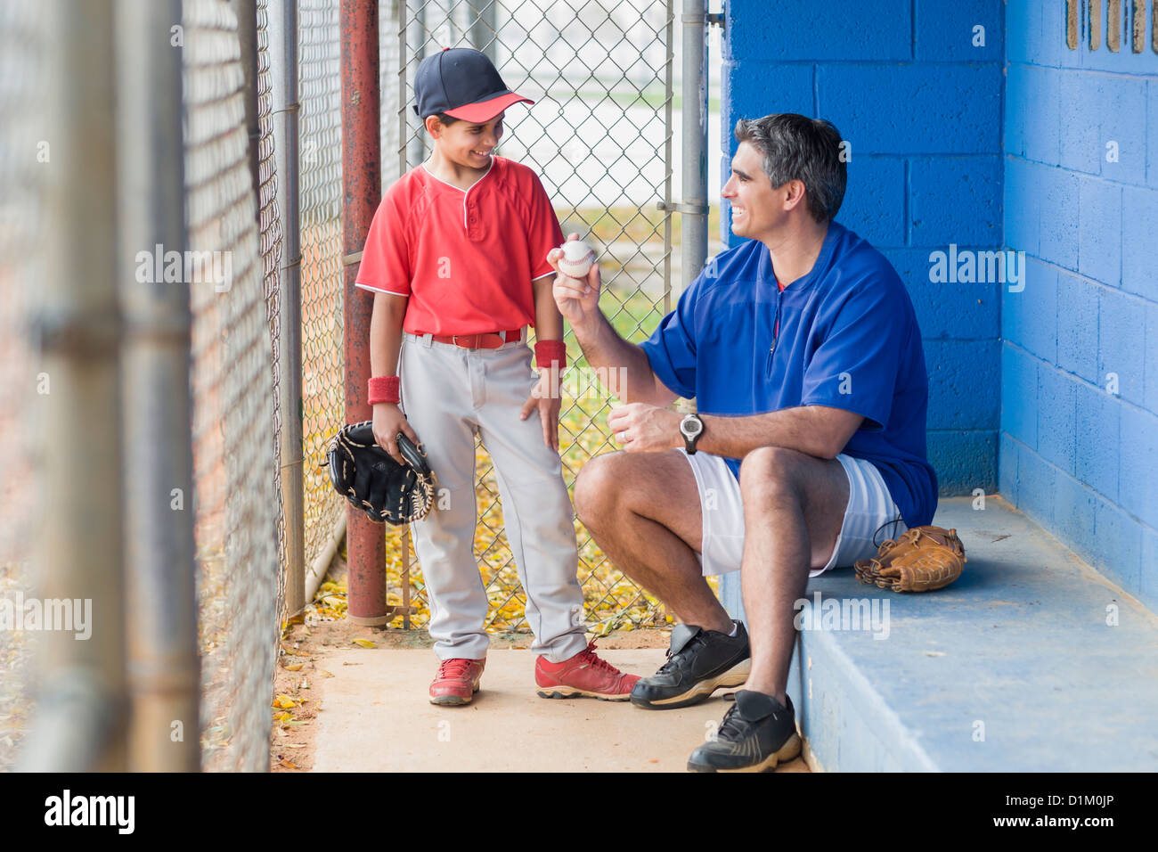 Hispanic coach and young baseball player Stock Photo - Alamy