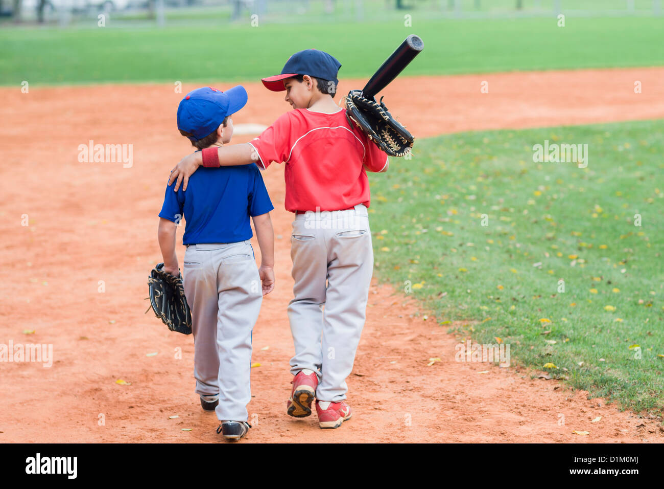 Hispanic boys on baseball field Stock Photo - Alamy