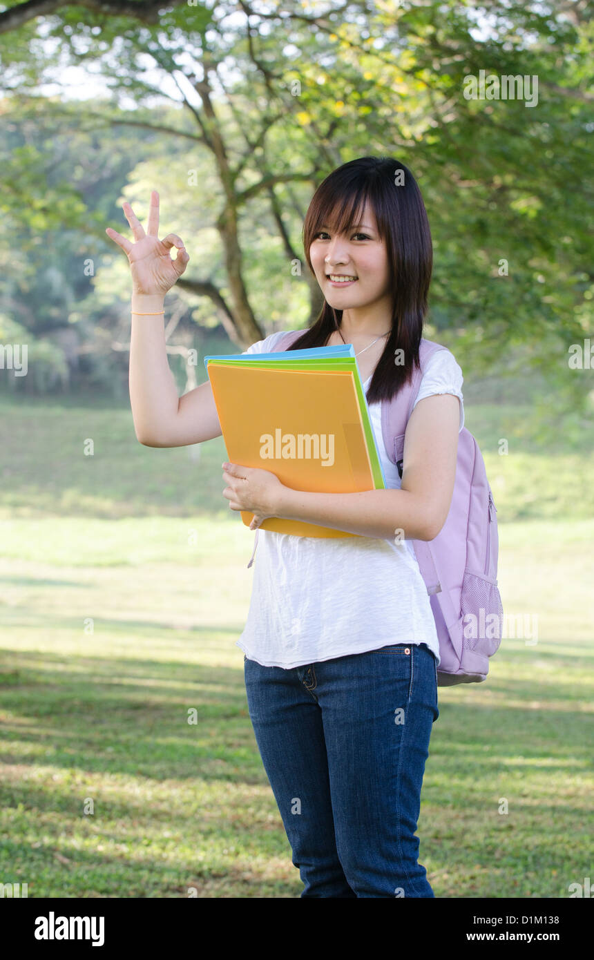 Smiling ok hand sign sitting girl hi-res stock photography and images ...