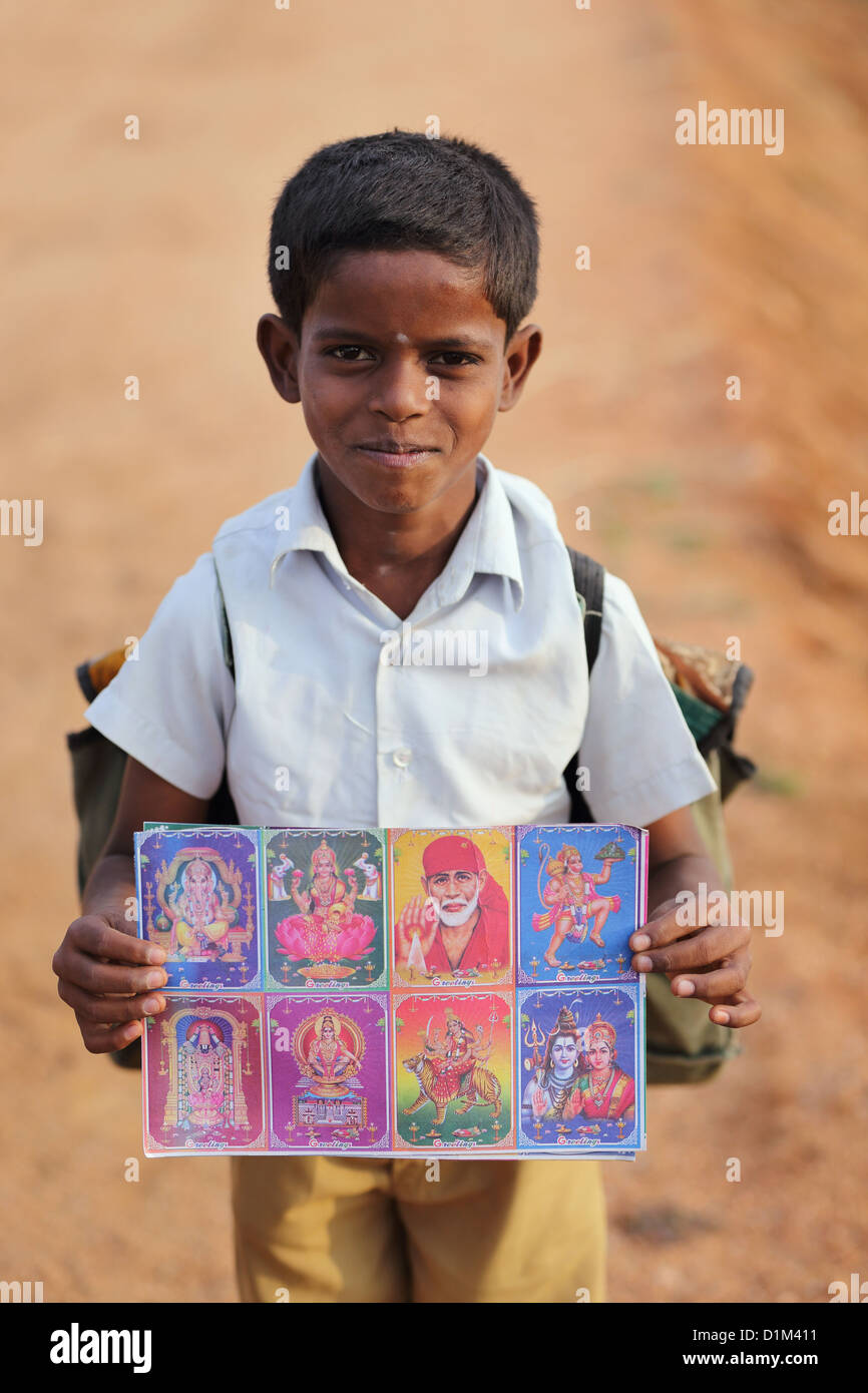 School kid holding a poster with Hindu Gods Andhra Pradesh South India ...