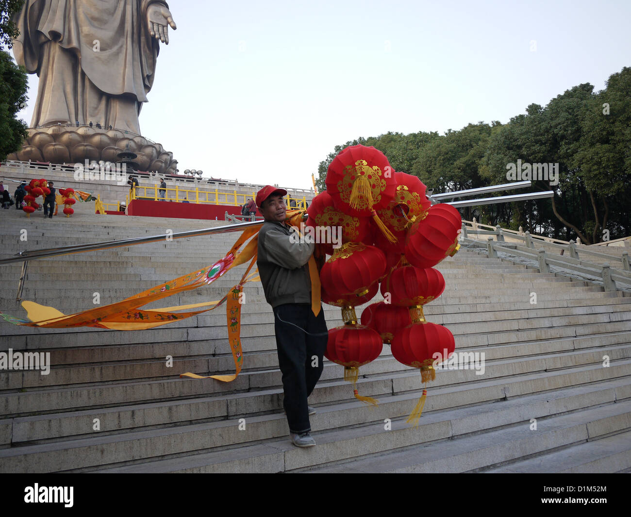 man carrying chinese lantern asian worker Stock Photo - Alamy