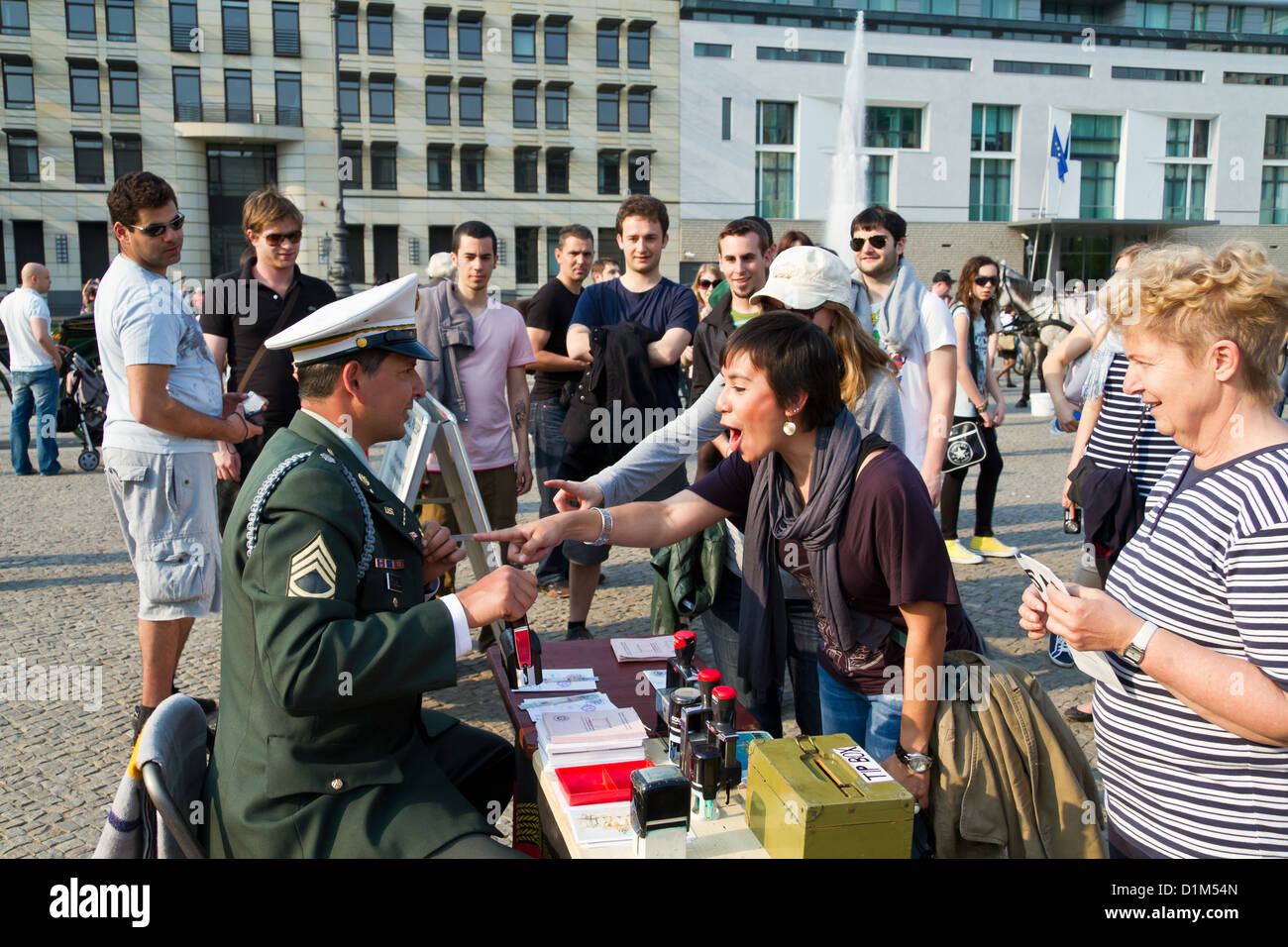 Actors performing as former East German Border Officers issuing Visa at ...