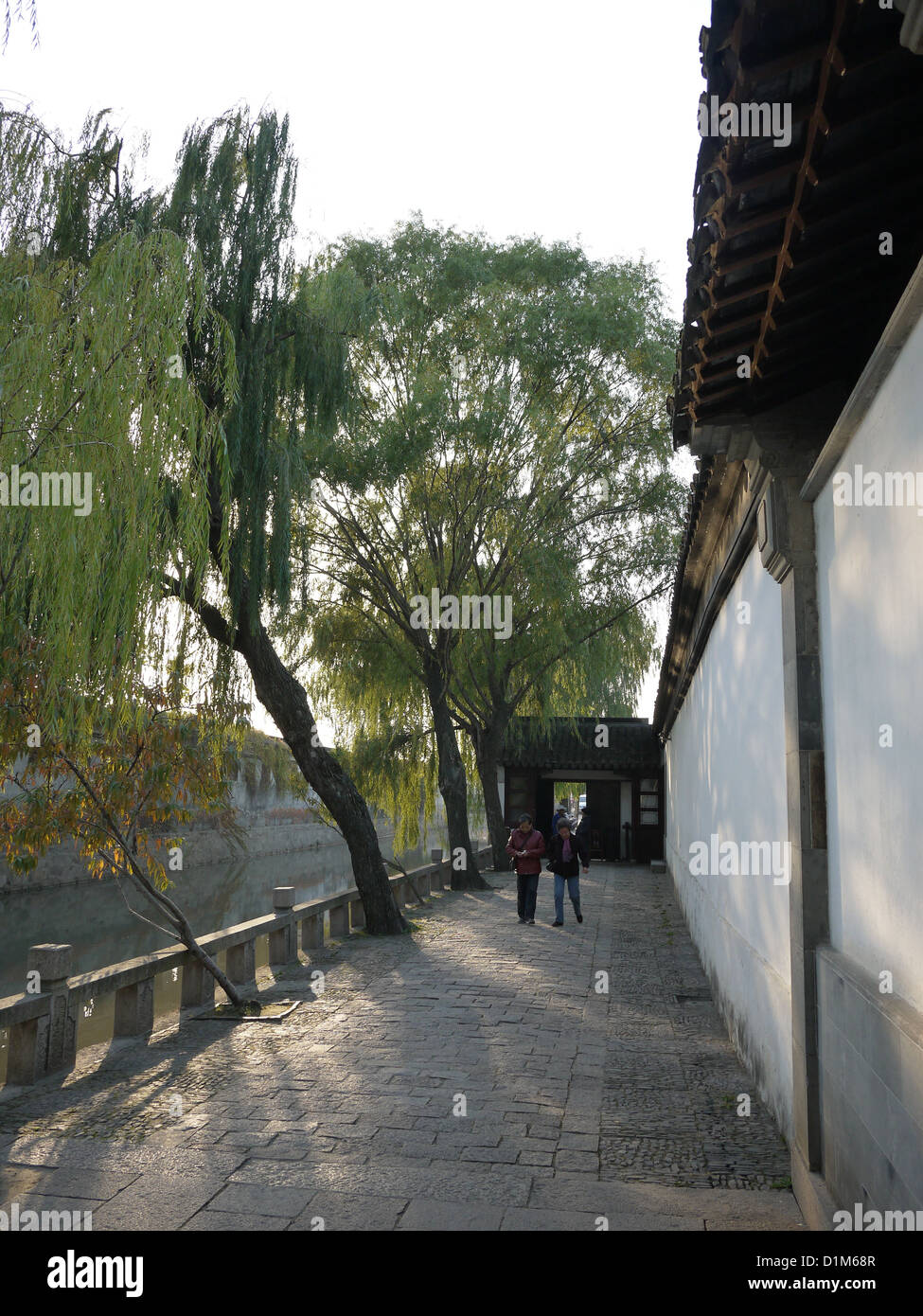pathway walkway brick wall tree sunset china Stock Photo - Alamy