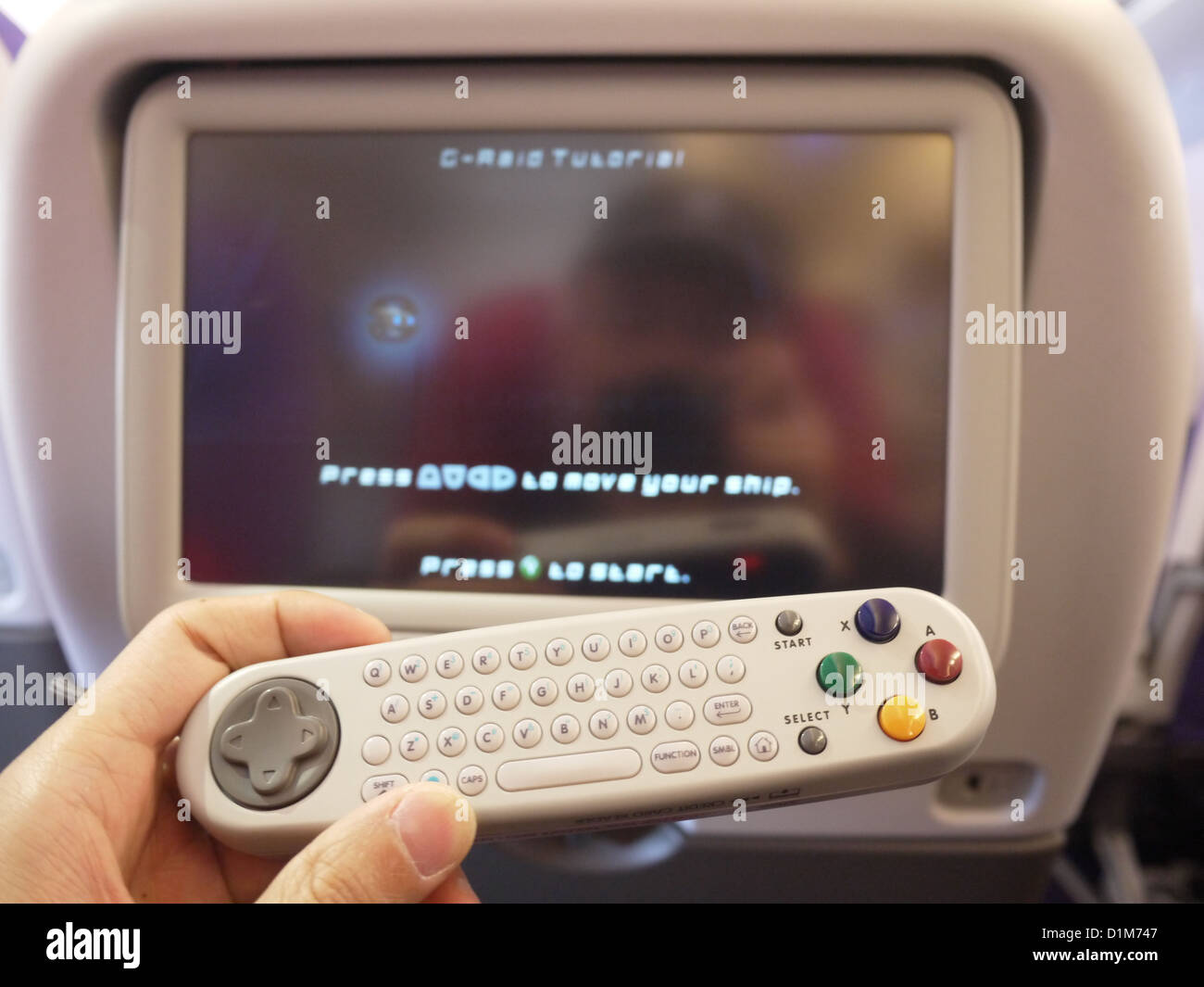gamepad joypad in-flight gaming system airplane Stock Photo - Alamy