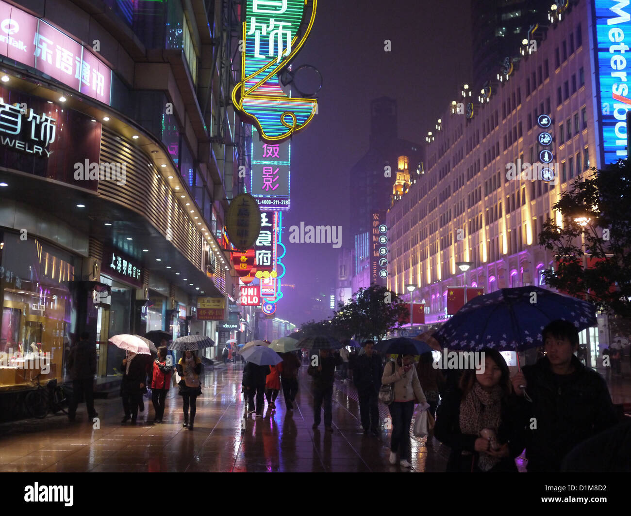 street crowd raining night neon sign China Stock Photo - Alamy
