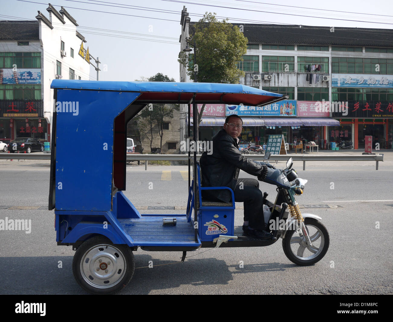 man male driving rickshaw motor bike blue china Stock Photo - Alamy