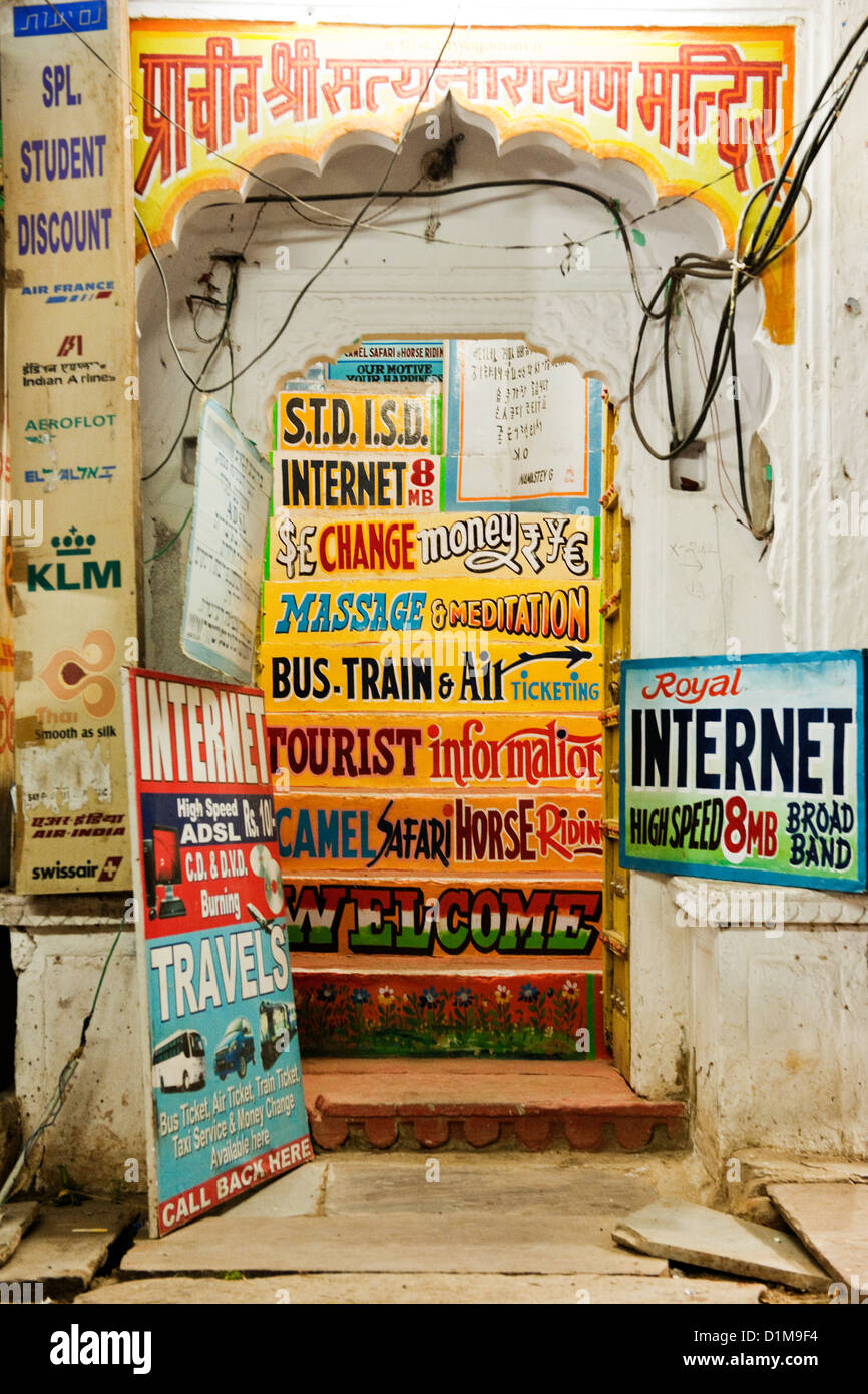 A colorful entrance to a shop advertising travel and internet on the ...