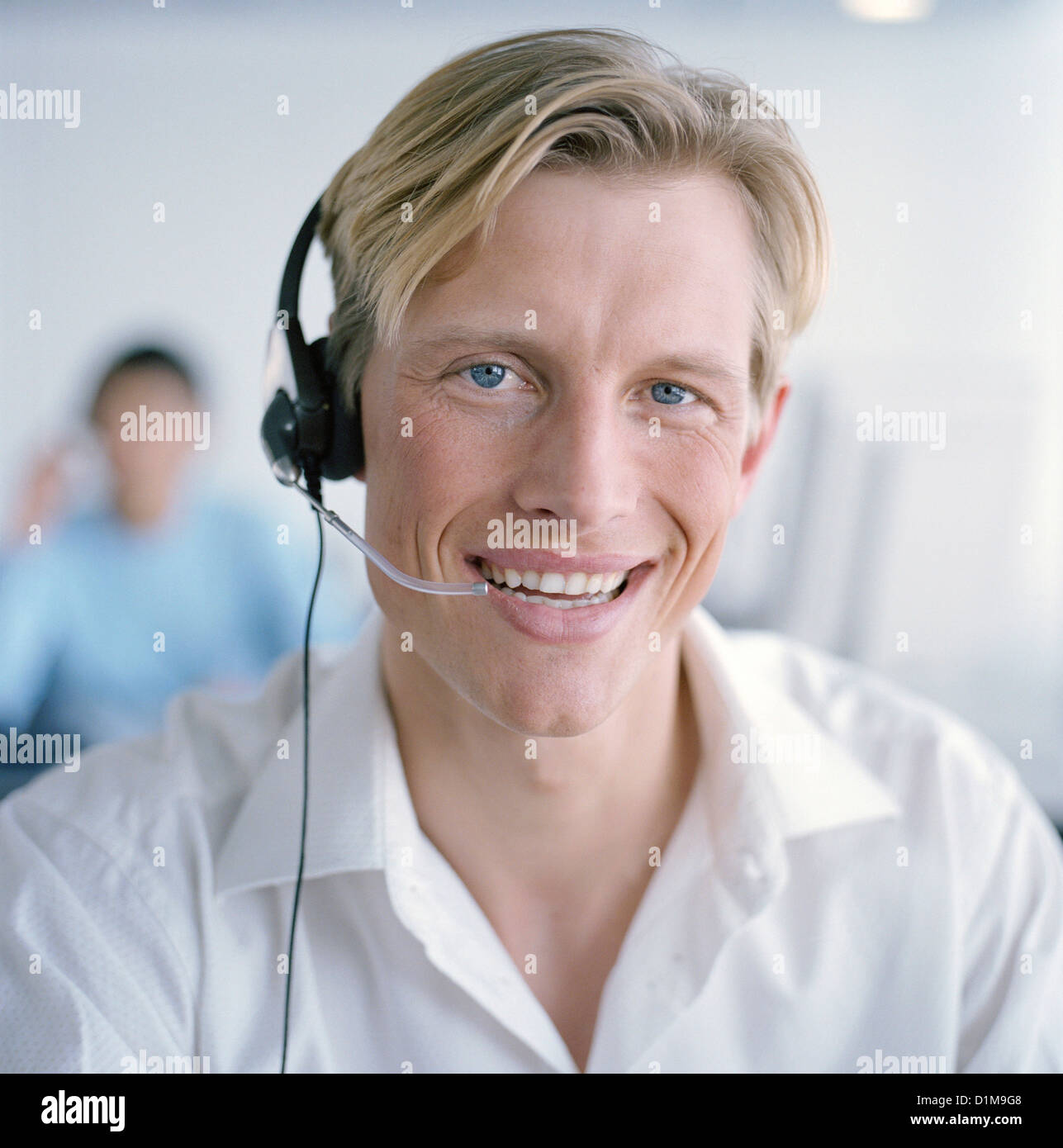 Closeup portrait of beautiful call centre employee smiling with headset ...
