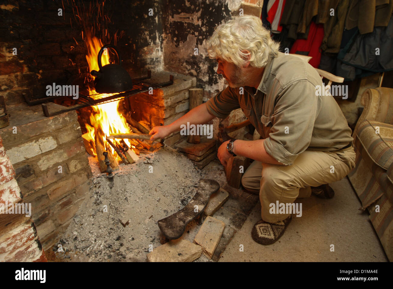 VINCE THURKETTLE LIGHTING A FIRE AT HIS HOME IN GREAT HOCKHAM,NORFOLK ...