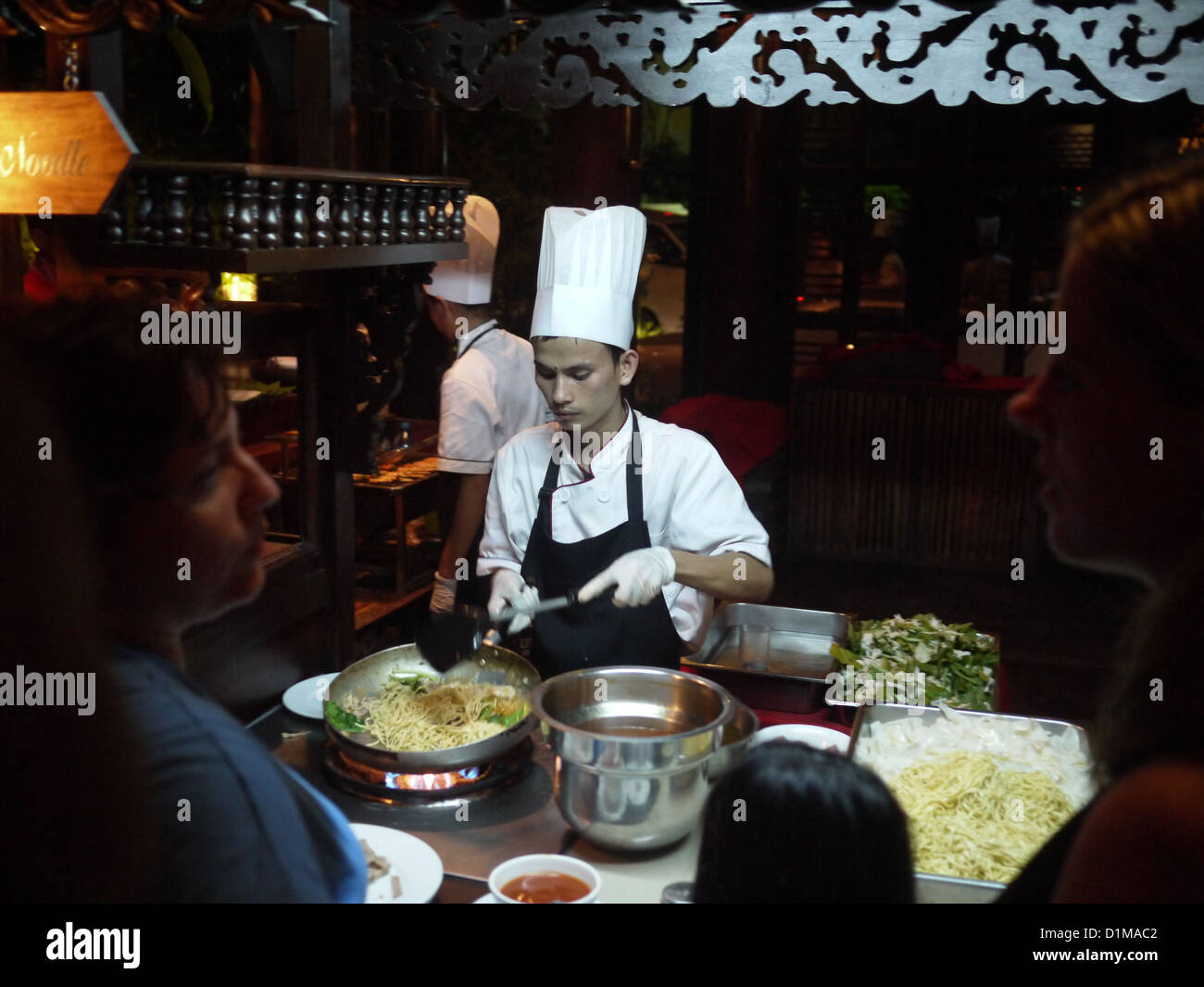 Asian chef cooking using wok Stock Photo - Alamy