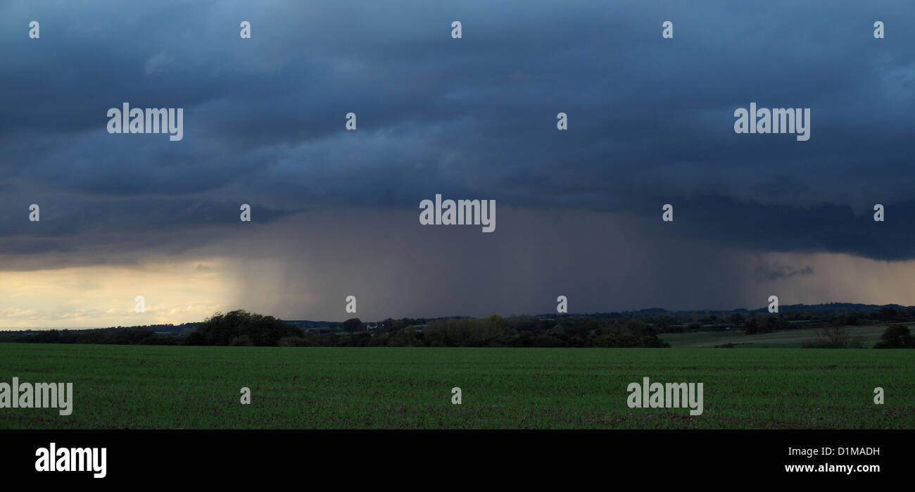 A downpour from a distant rain storm and a dark cloud drenches ...