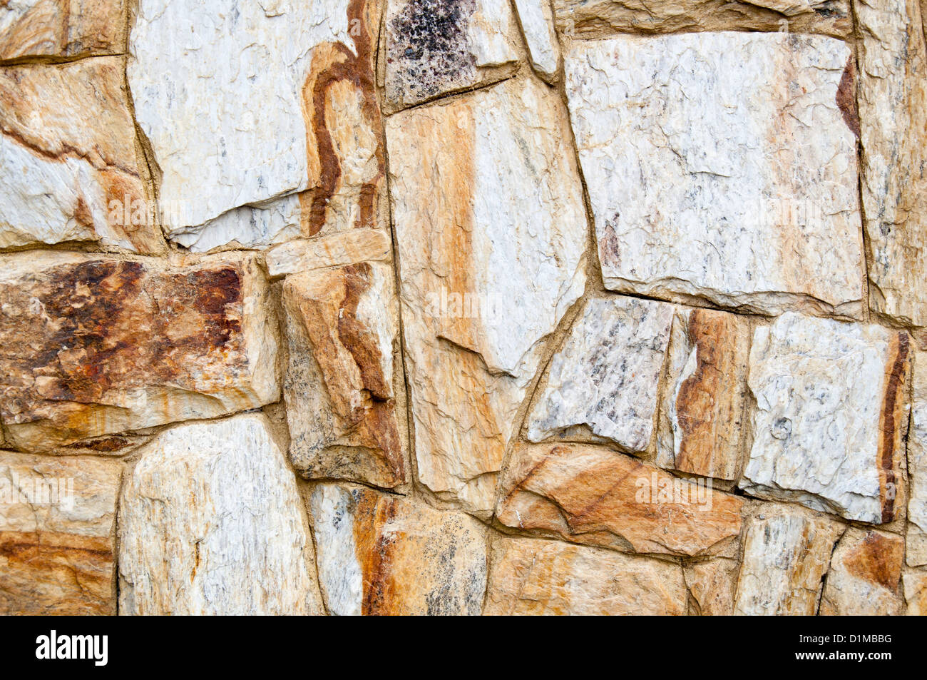 Stone wall background of construction material Stock Photo - Alamy