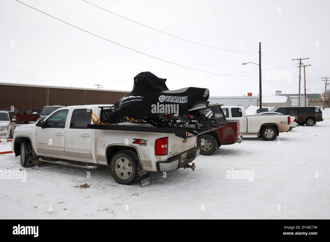 snowmobile on the back of a pickup truck in a parking lot Kamsack ...