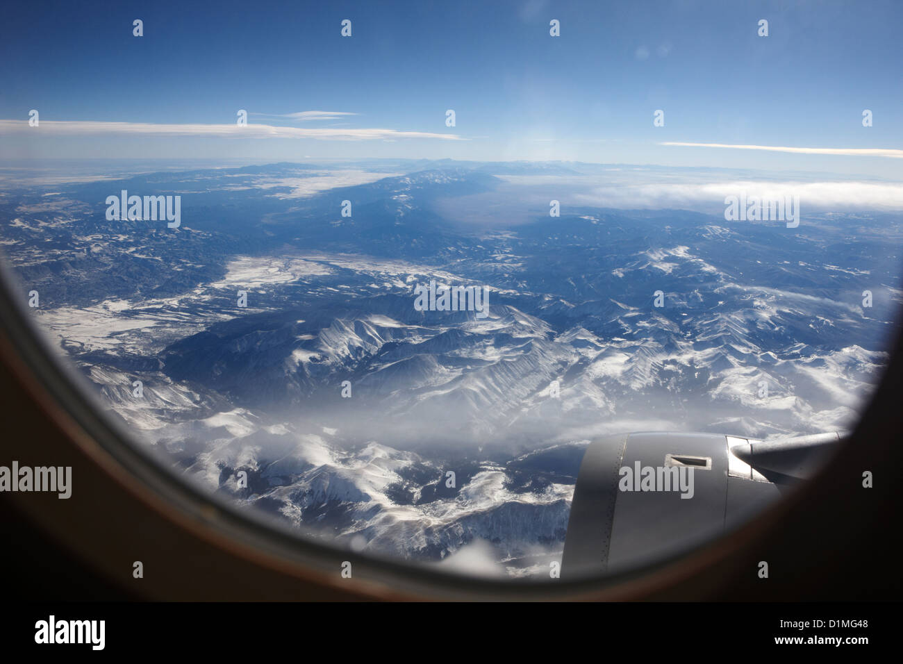 looking out of aircraft window flying over rocky mountains in the USA ...