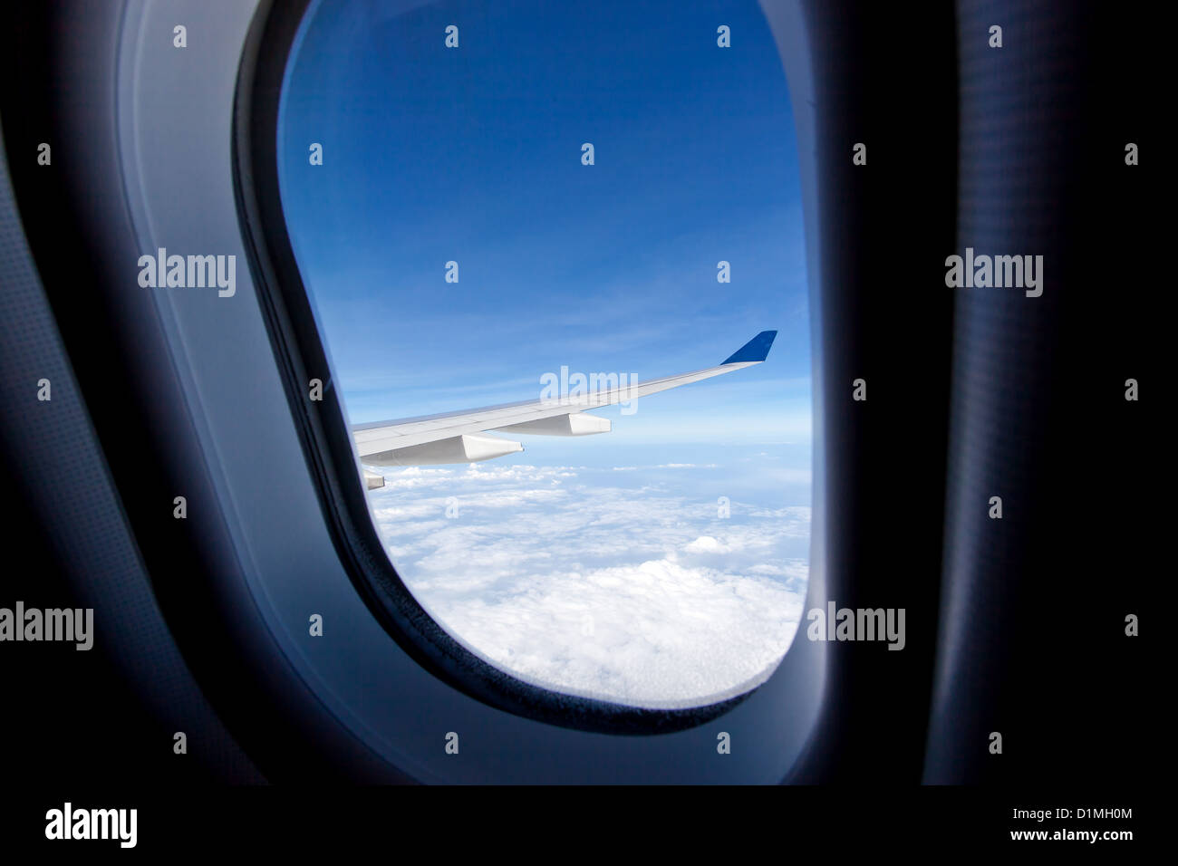 Wing of airplane, view through the window Stock Photo - Alamy