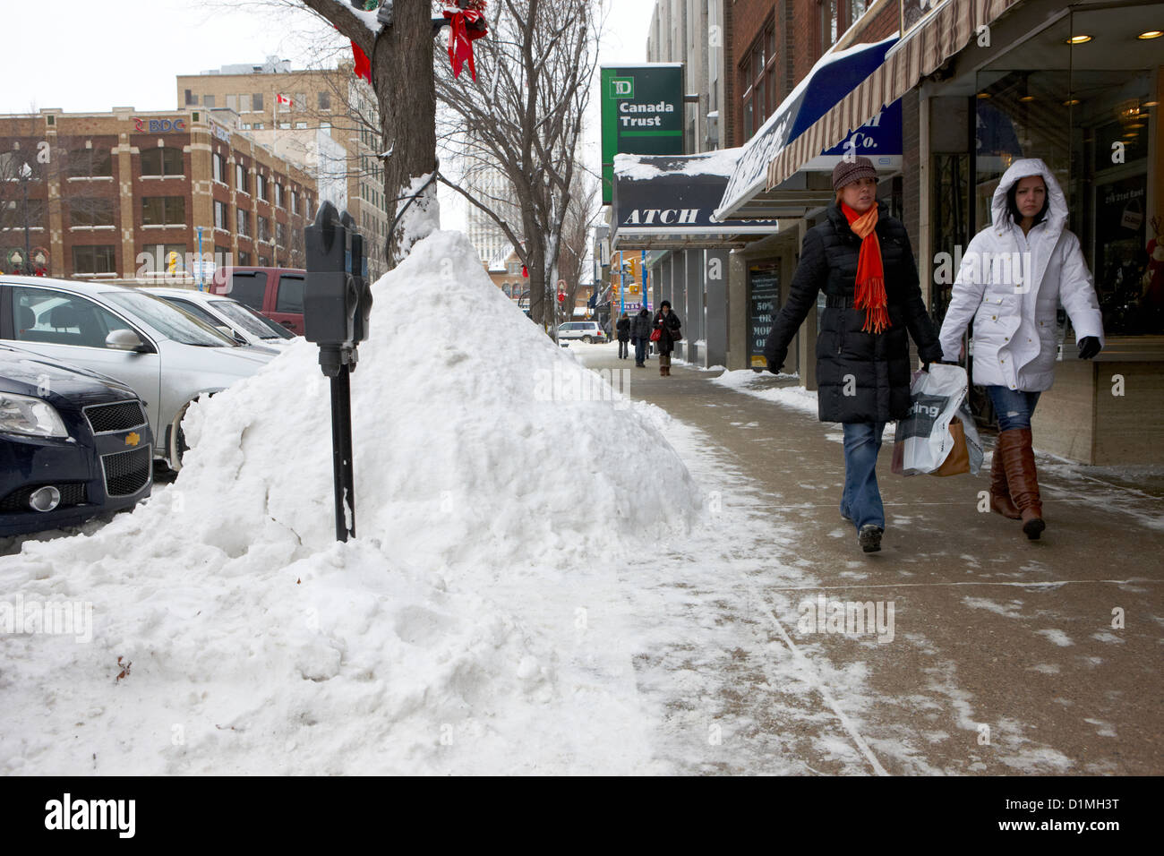 people walking along clear sidewalks in downtown city street Saskatoon ...